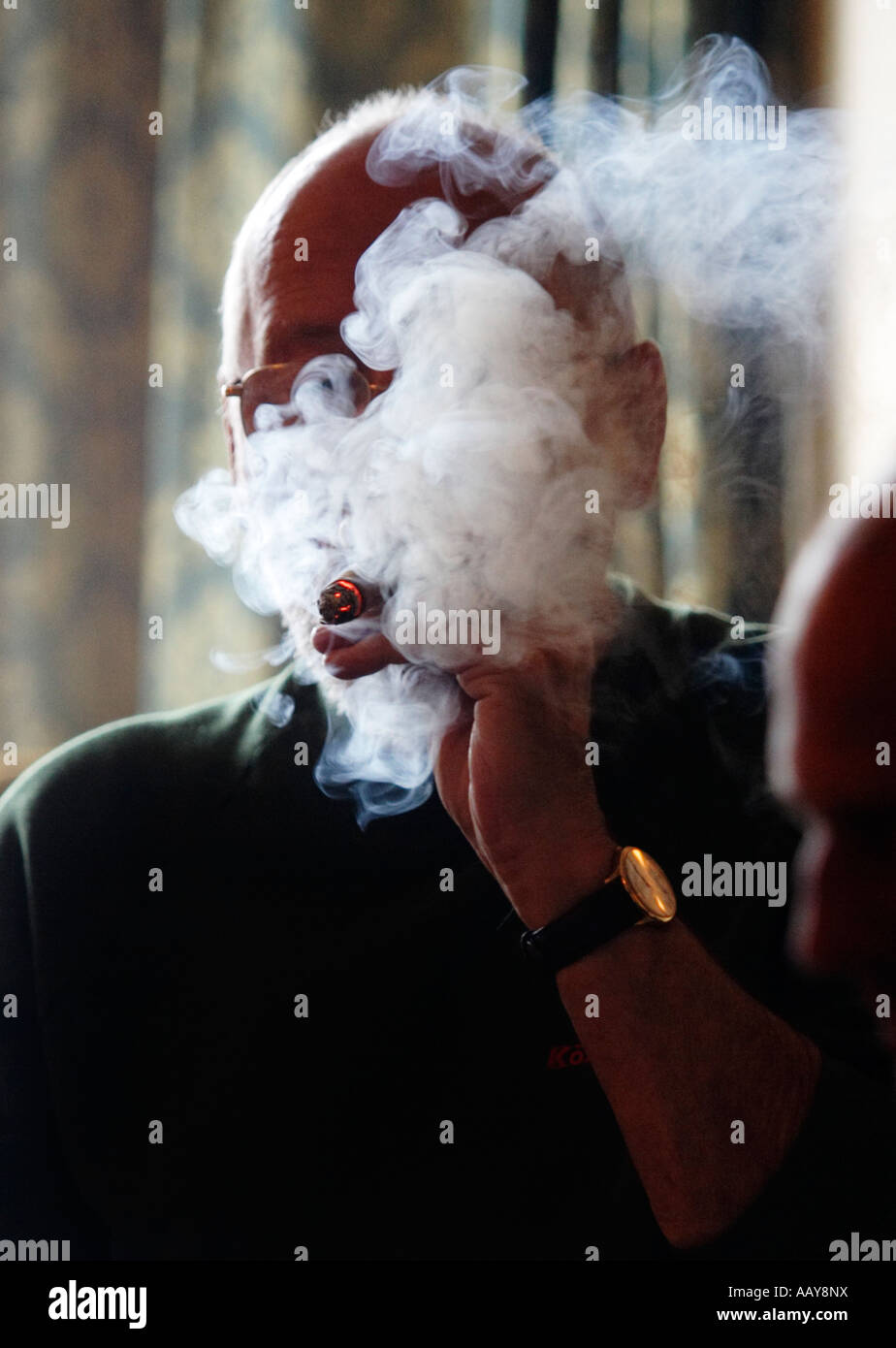 A cigar smoker in a pub in Redditch Worcestershire UK on the last day ...