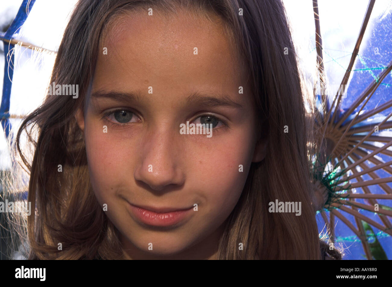 young girl smiling cheekily warily Stock Photo - Alamy