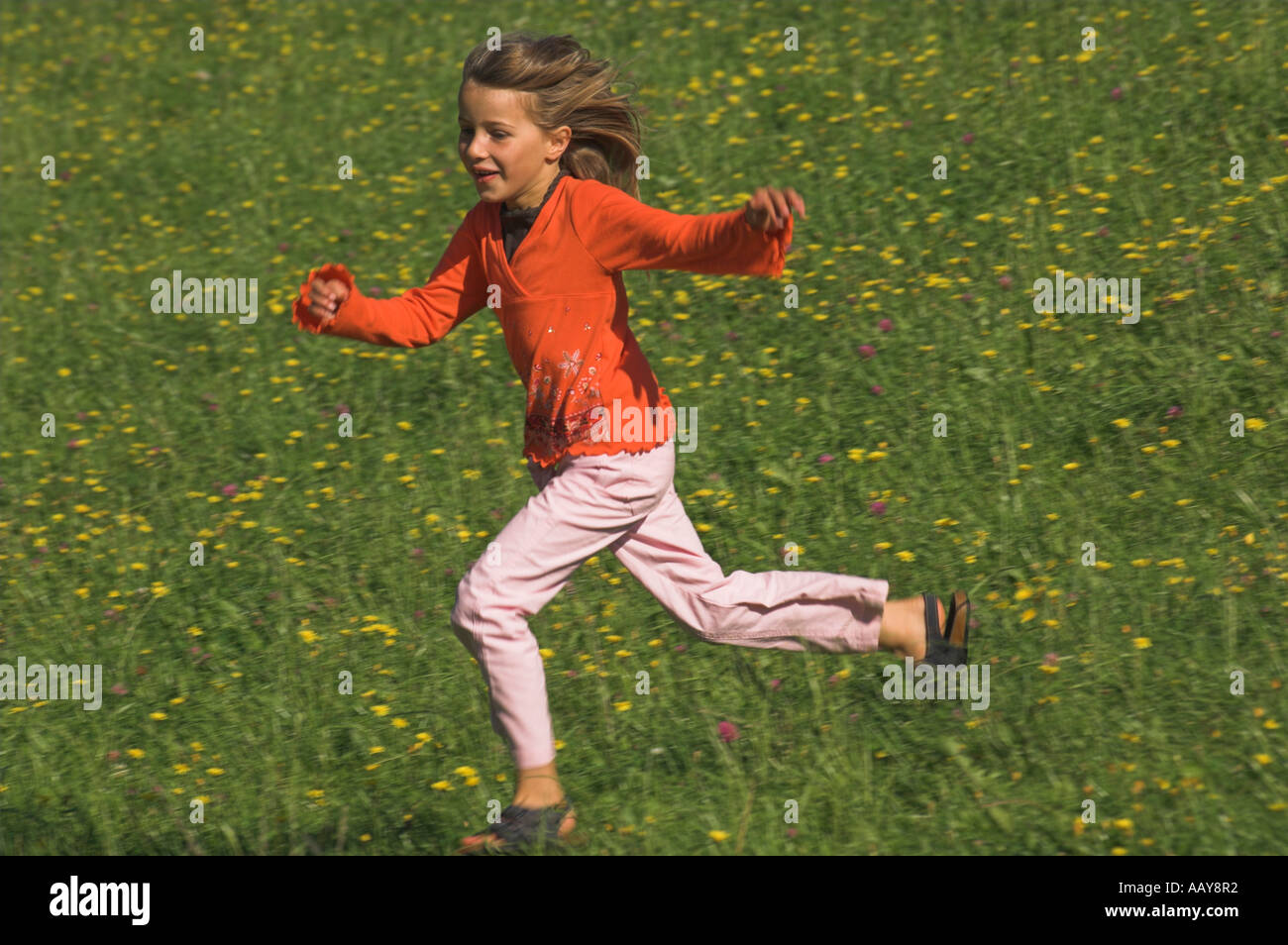 girl child running through a field Stock Photo - Alamy