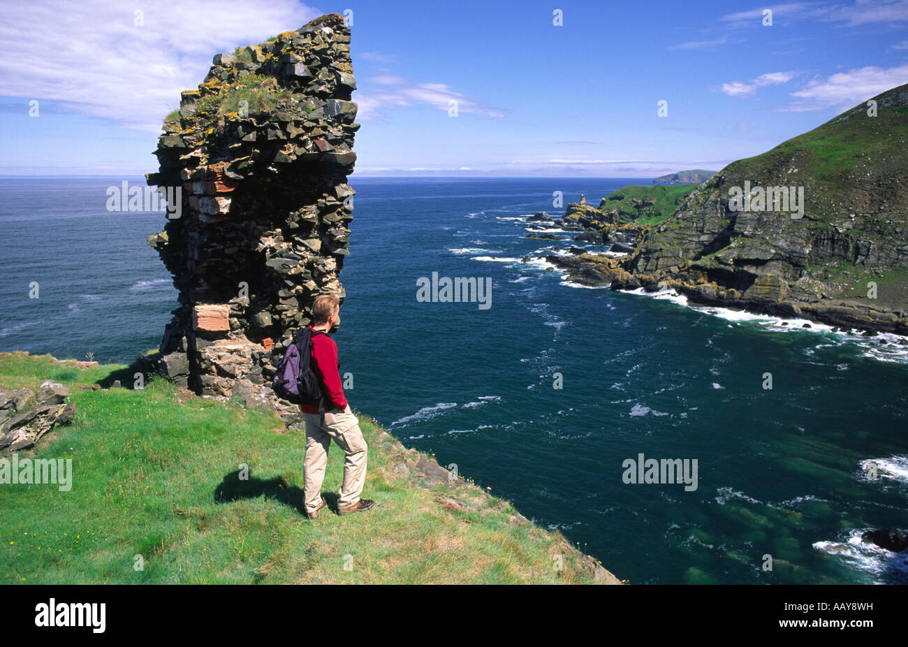 Coastal walks walker at remains of Fast Castle looking to sea stack and ...