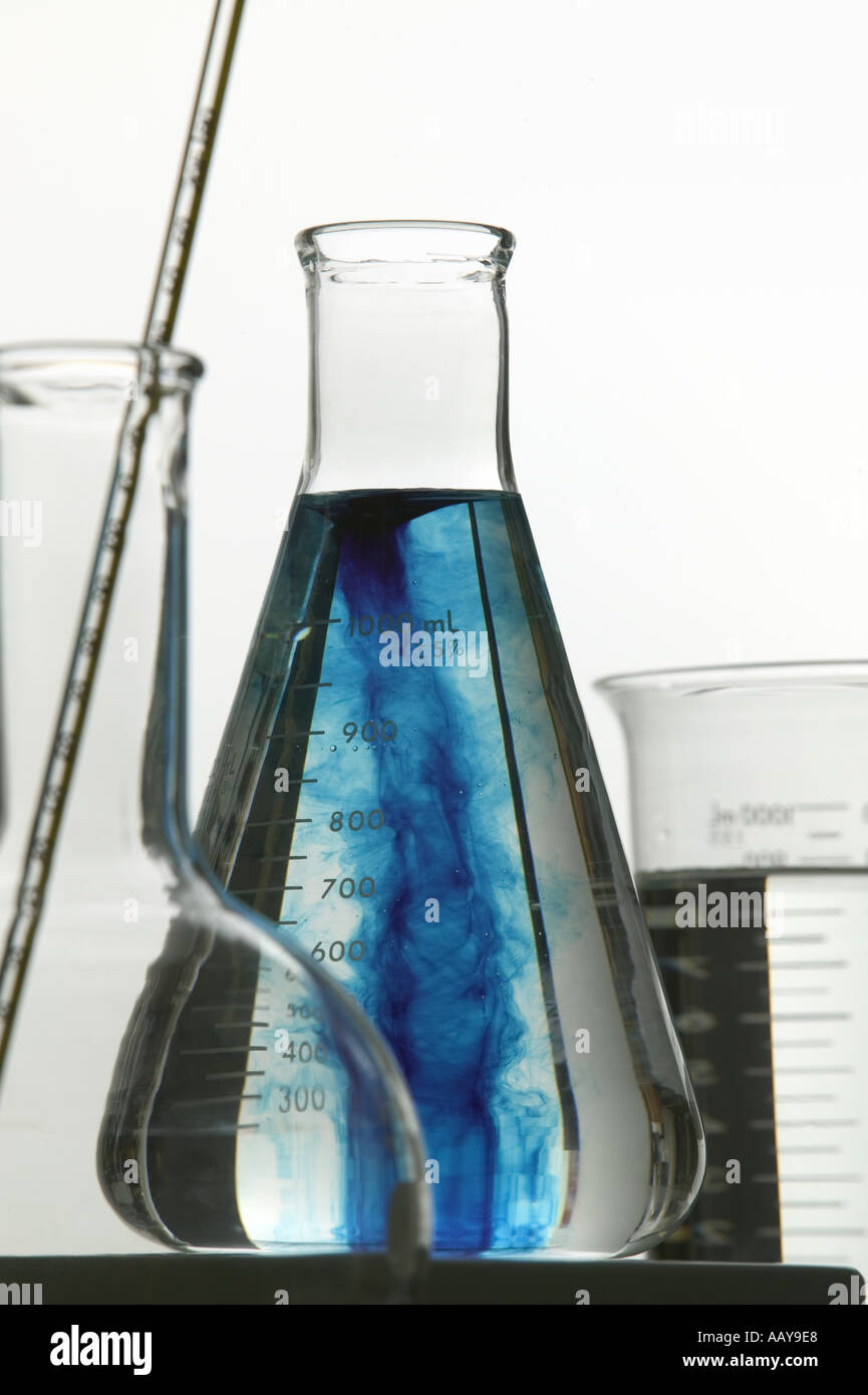 Chemical beakers flasks and other glassware still life on a white ...