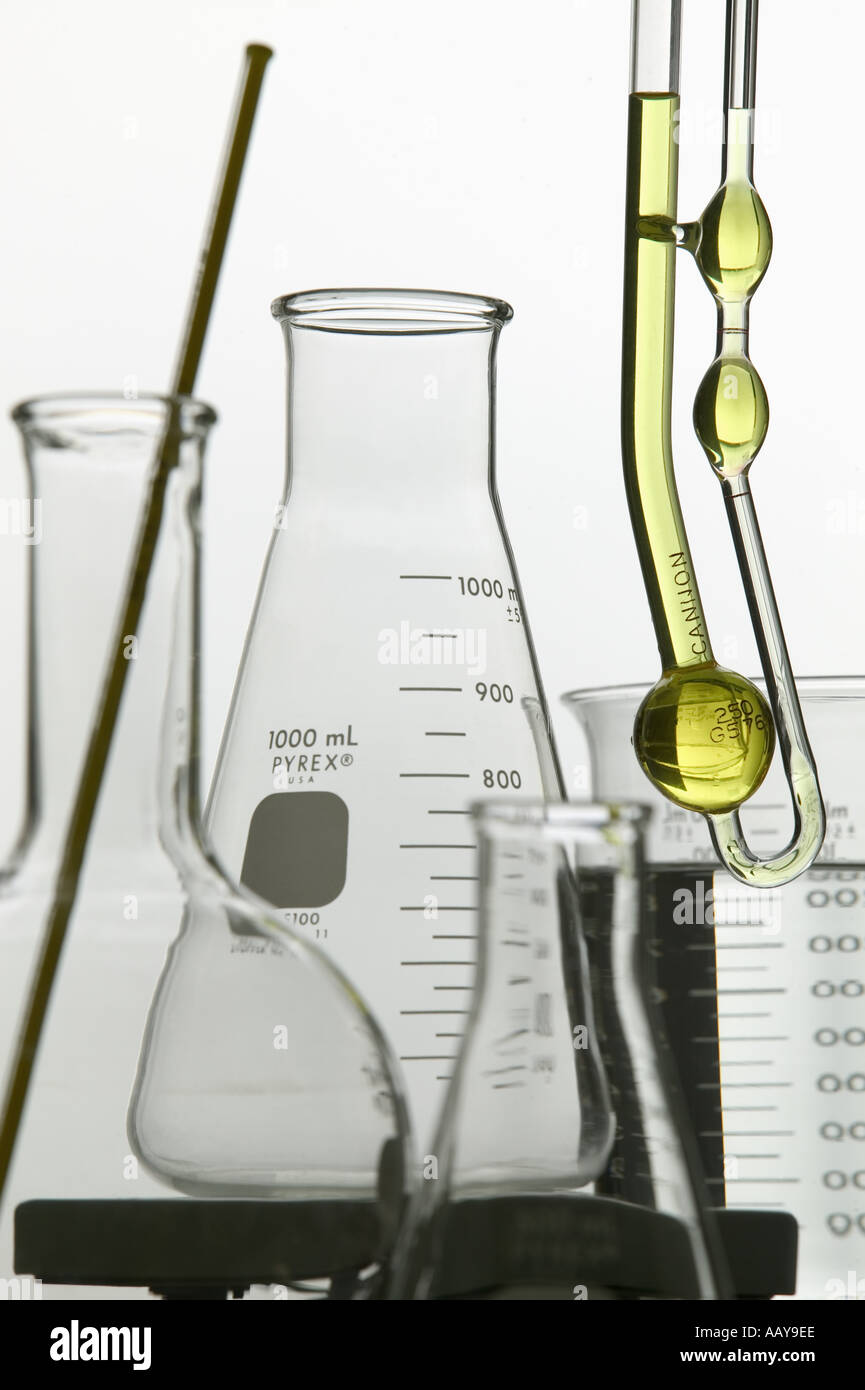 Chemical beakers flasks and other glassware still life on a white ...