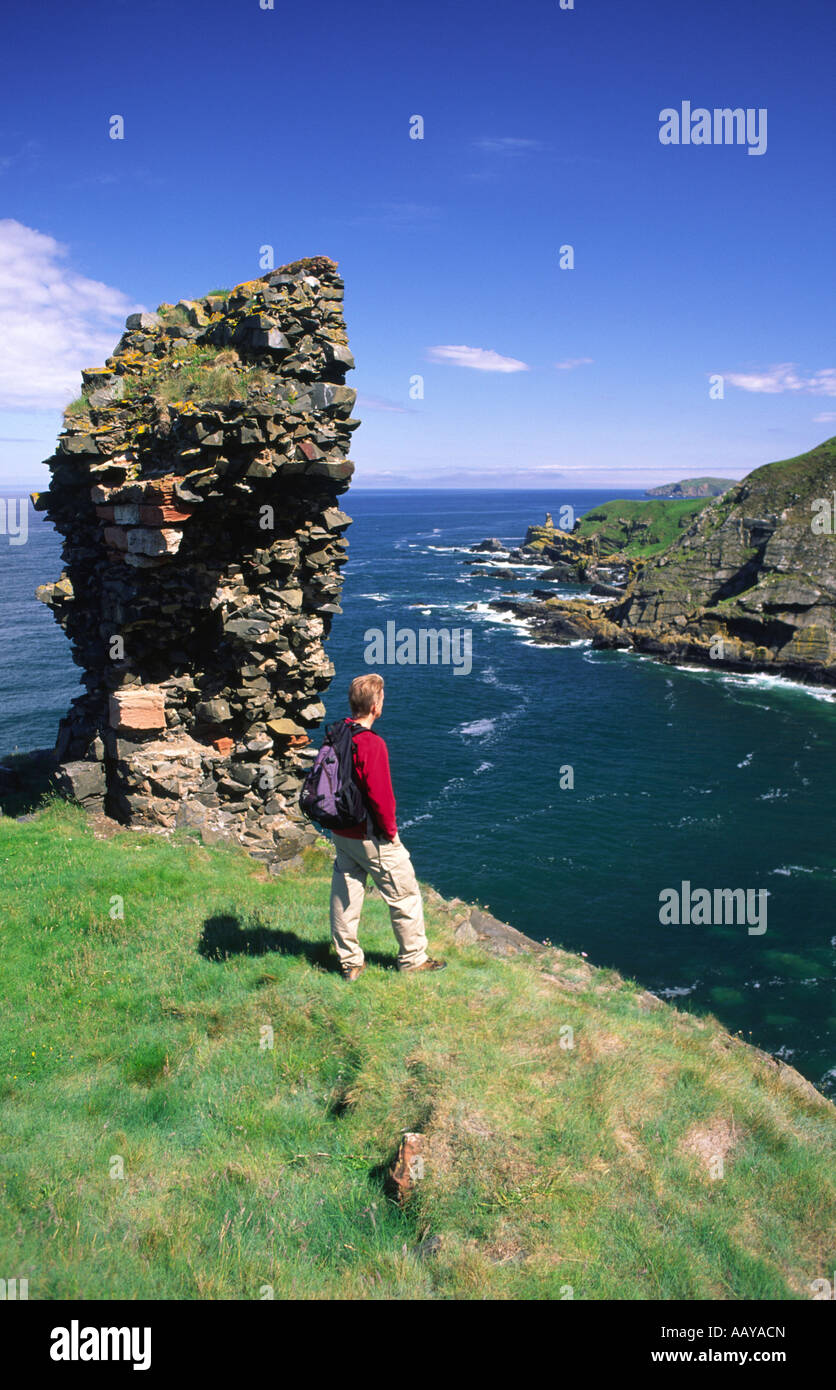 Coastal walks walker at remains of Fast Castle looking to sea stack and ...