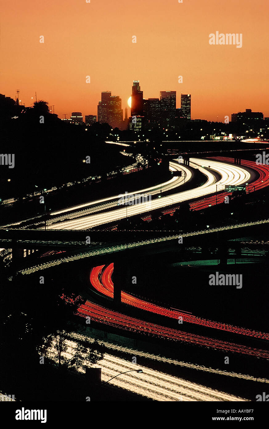 East of Los Angeles downtown at sunset as rush hour traffic paints ...