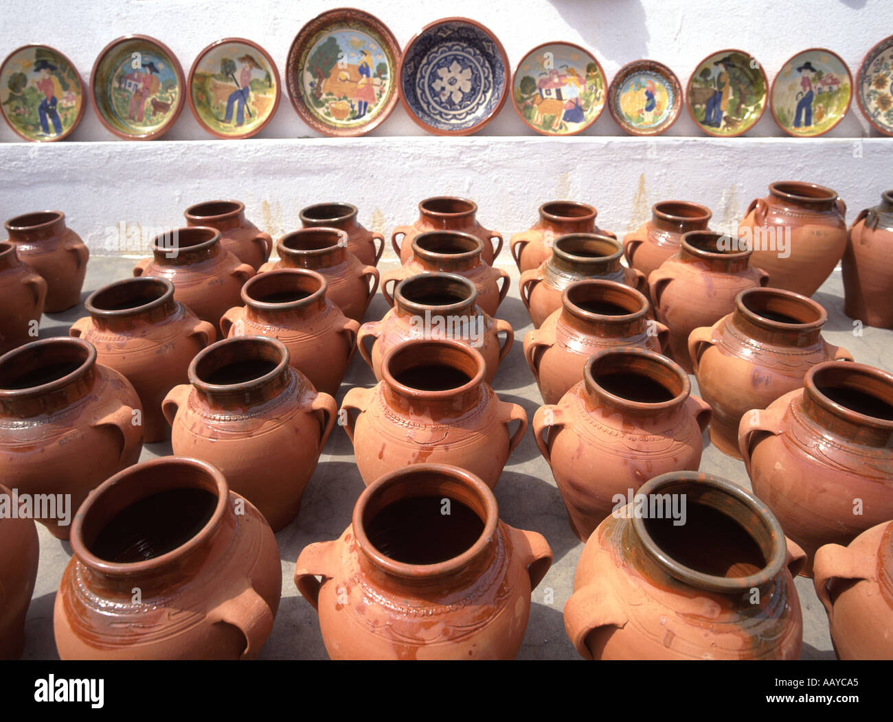Clay plant pots with handles and glazed plates on outdoor display at ...