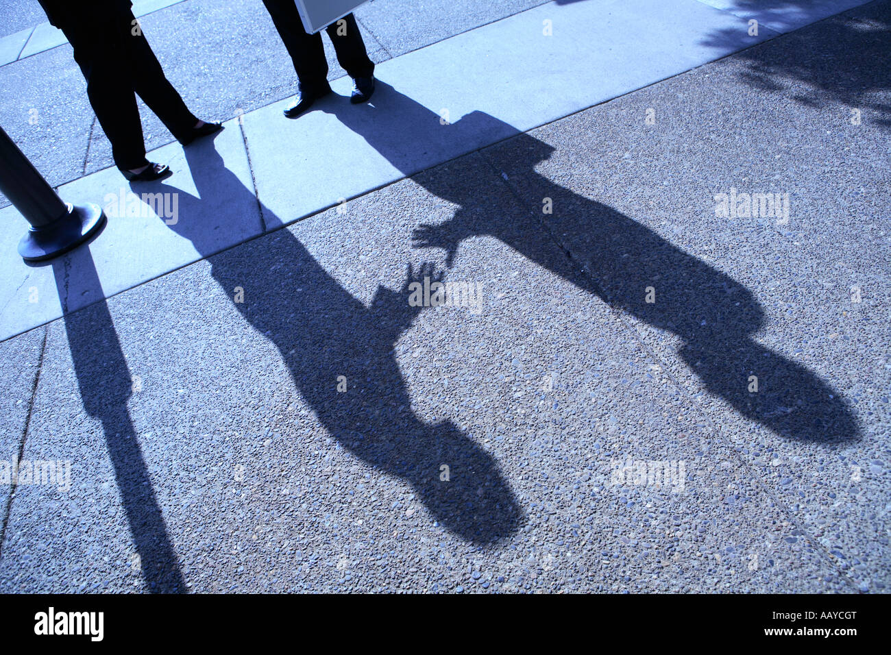 Businesspeople shaking hands with shadows on ground Stock Photo - Alamy