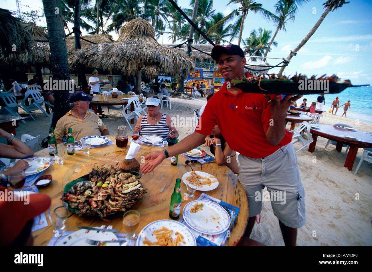 Waiter serving dishes at Captain Cook Restaurant Bavaro Punta Cana ...