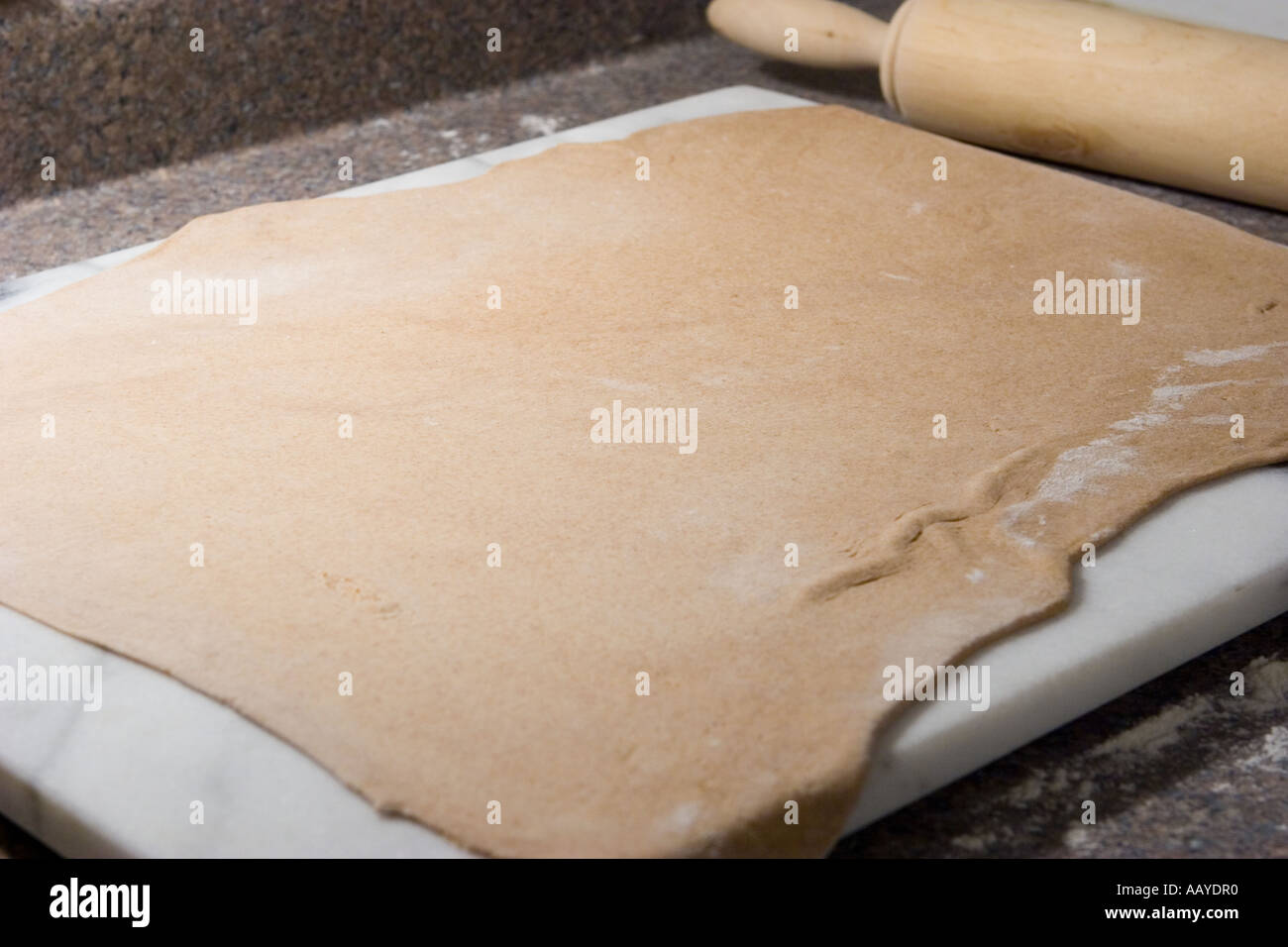 Dough is rolled out and prepared to begin cooking pepperoni calzone ...