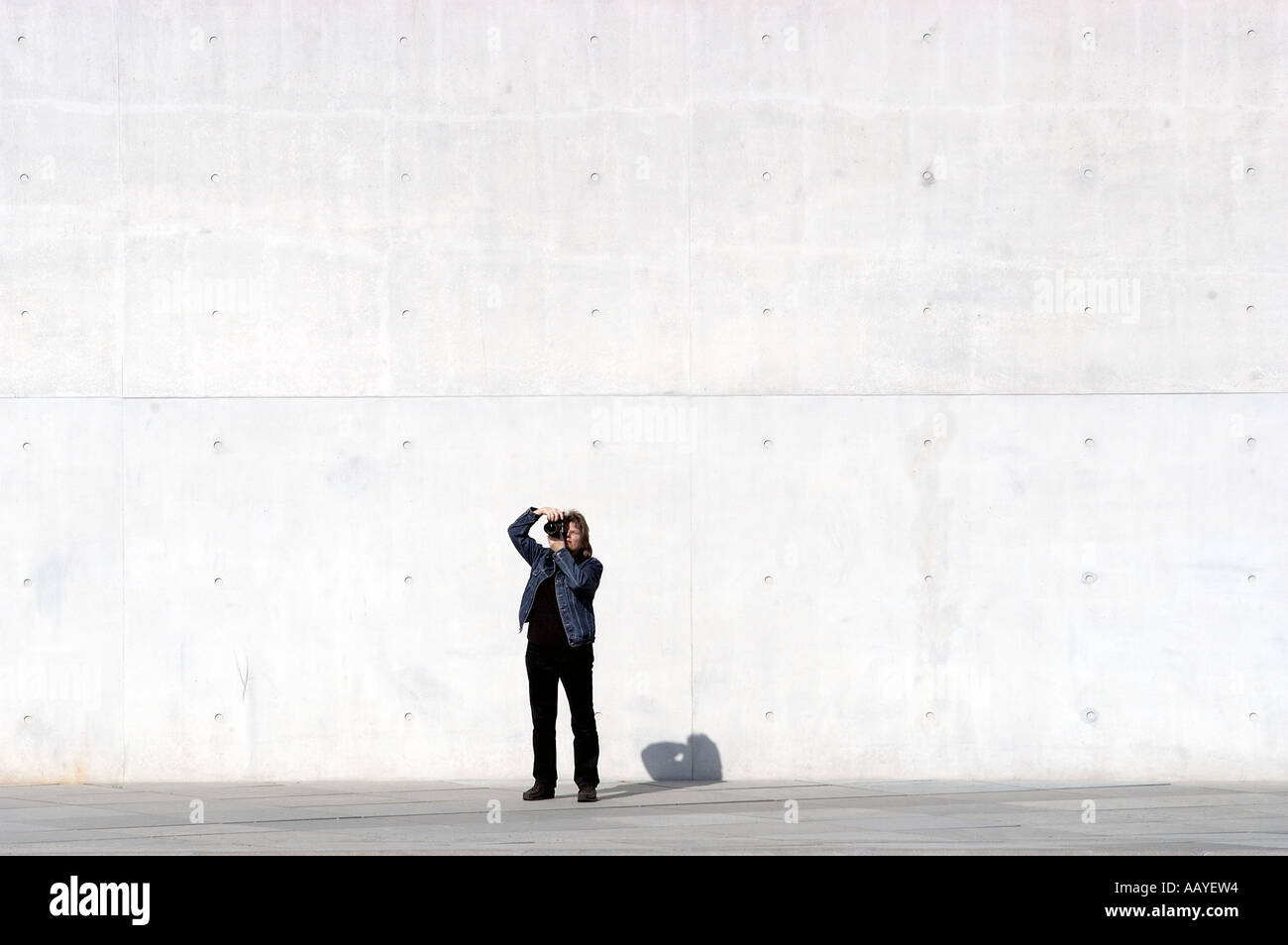 Woman taking a photography white wall background Stock Photo - Alamy
