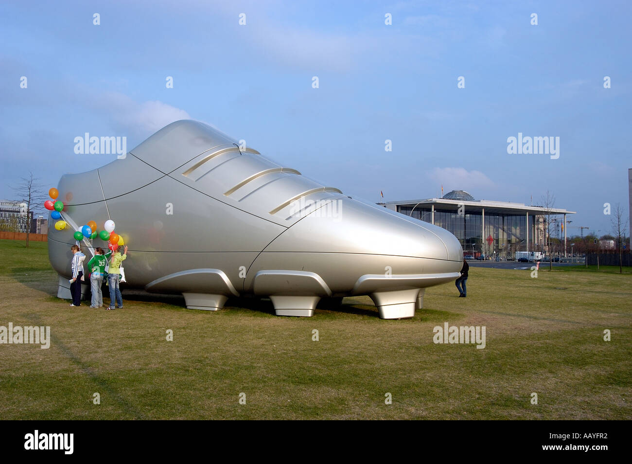 Giant pair of soccer football shoes sits in a park Stock Photo - Alamy