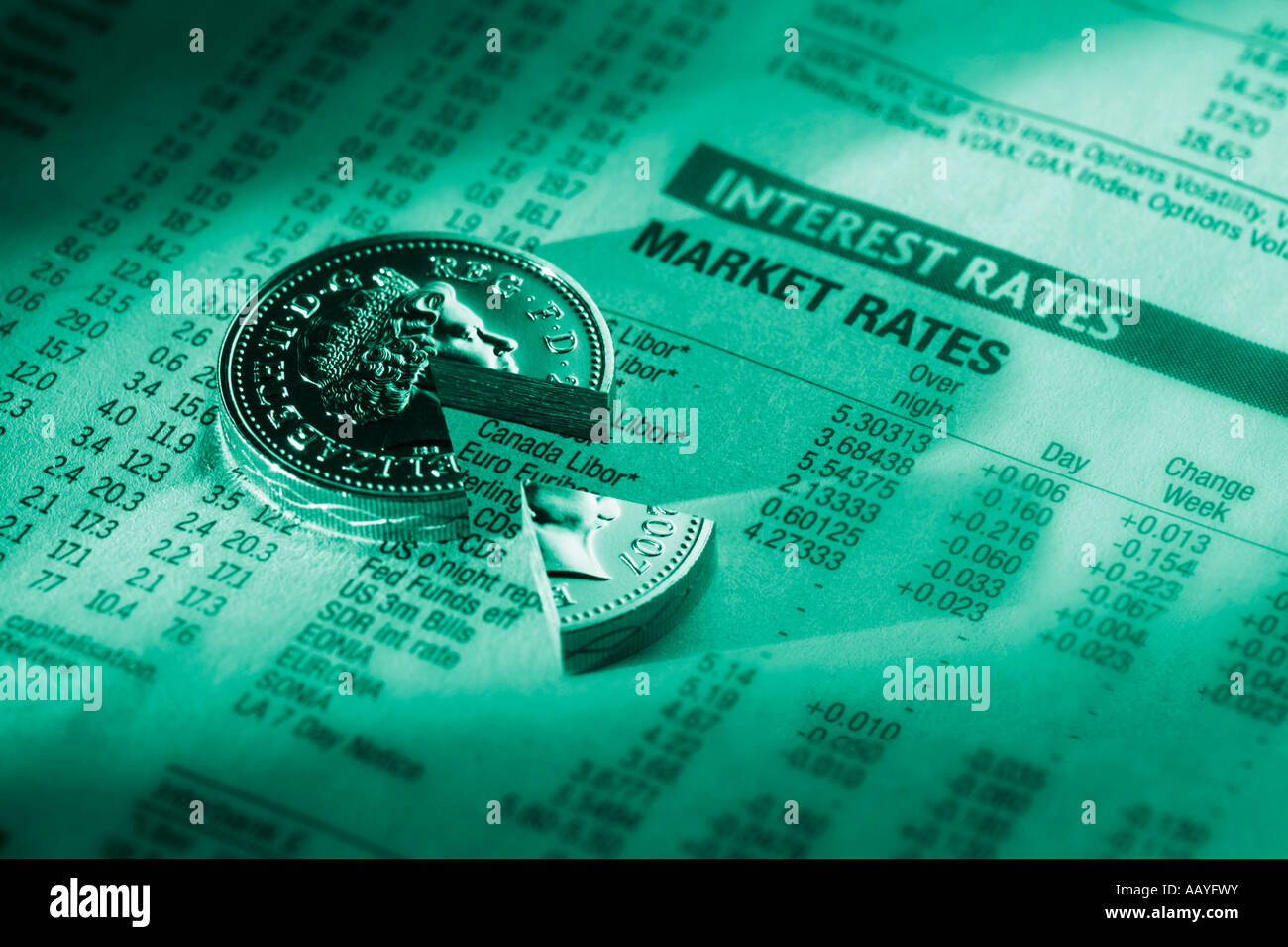 Pound coin with segment cut out on financial pages of newspaper Stock ...
