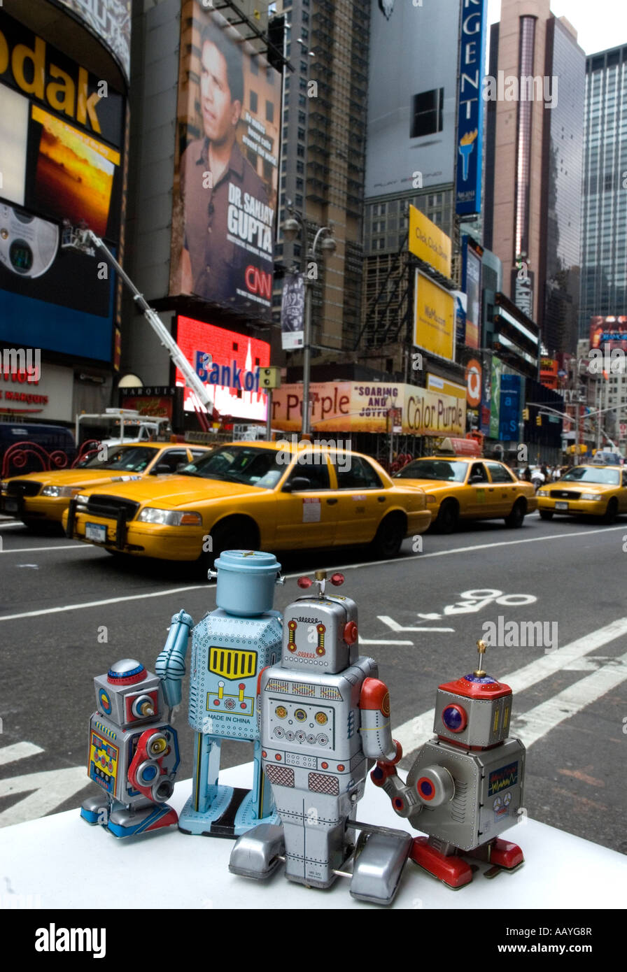 Four toy robots sightseeing in Times Square New York with yellow taxis ...