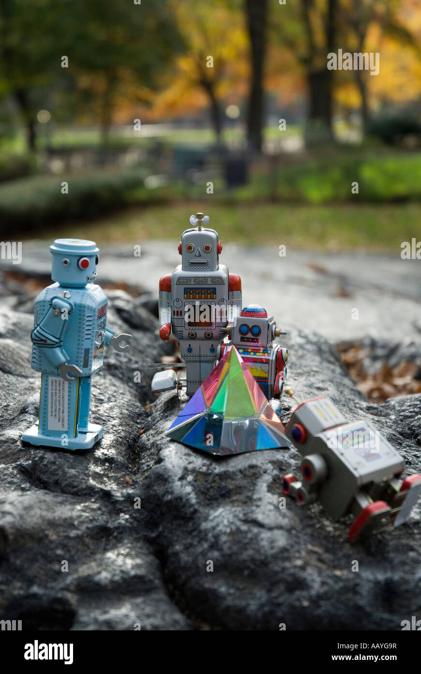Four toy robots worshipping a glass pyramid in Central Park New York ...