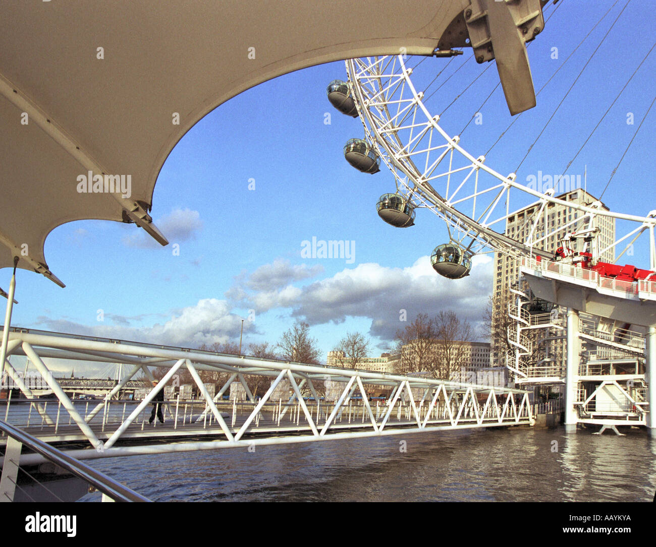 London eye with walkway across River Thames from waterloo river boat ...