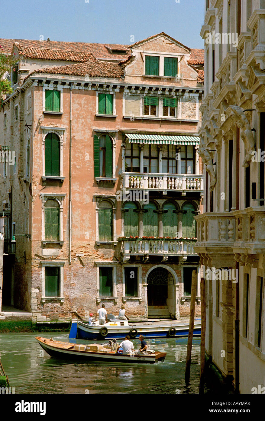 A typical scene in Venice with boats bridges ancient buildings and ...