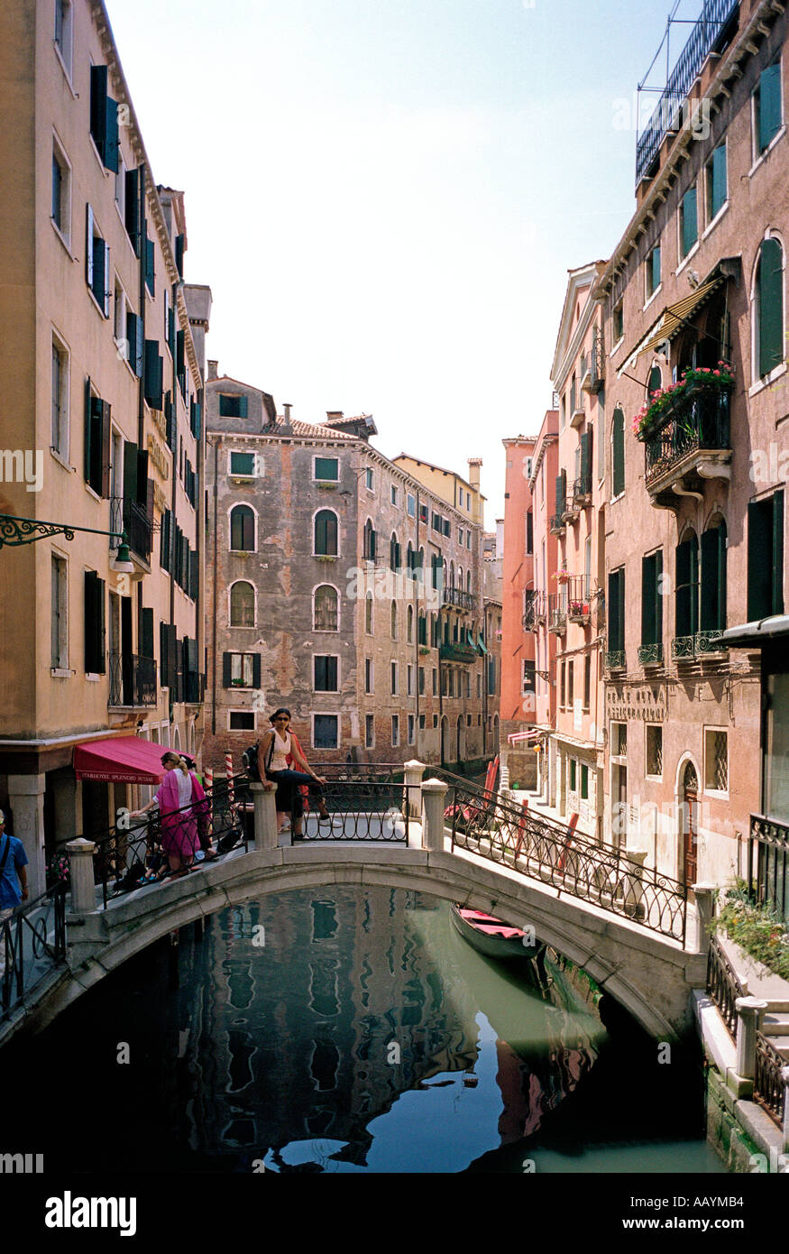 A typical scene in Venice with boats bridges ancient buildings and ...