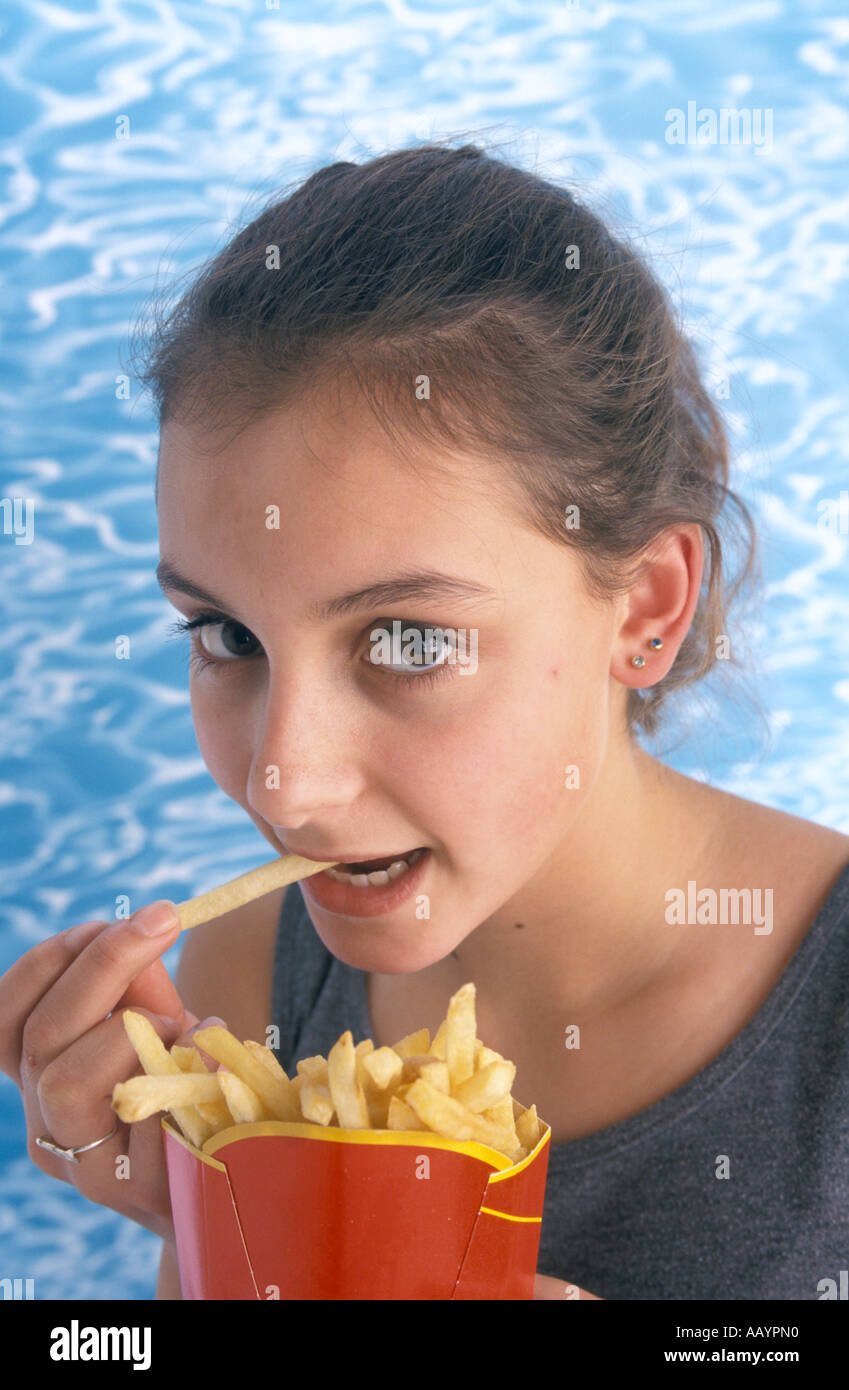 Teenage girl eating French fries Stock Photo - Alamy