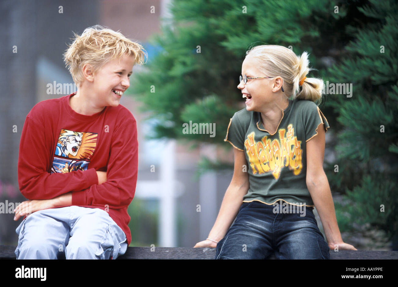 Teenage boy and teenage girl talking together Stock Photo - Alamy