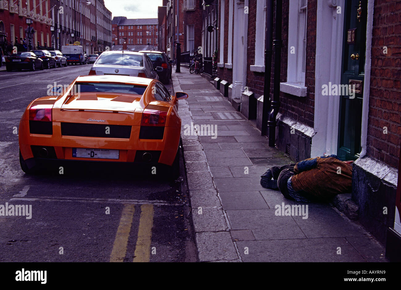Homeless Man Sleeping Beside Lamborghini Car Stock Photo - Alamy