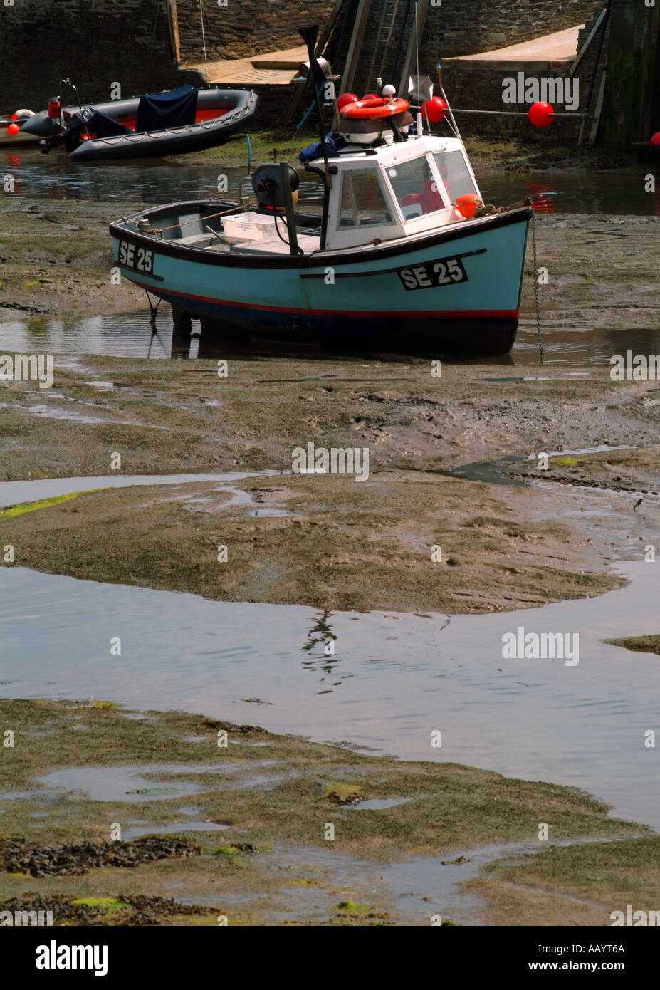 A small fishing boat moored on estuary mud flats Salcombe Devon UK ...