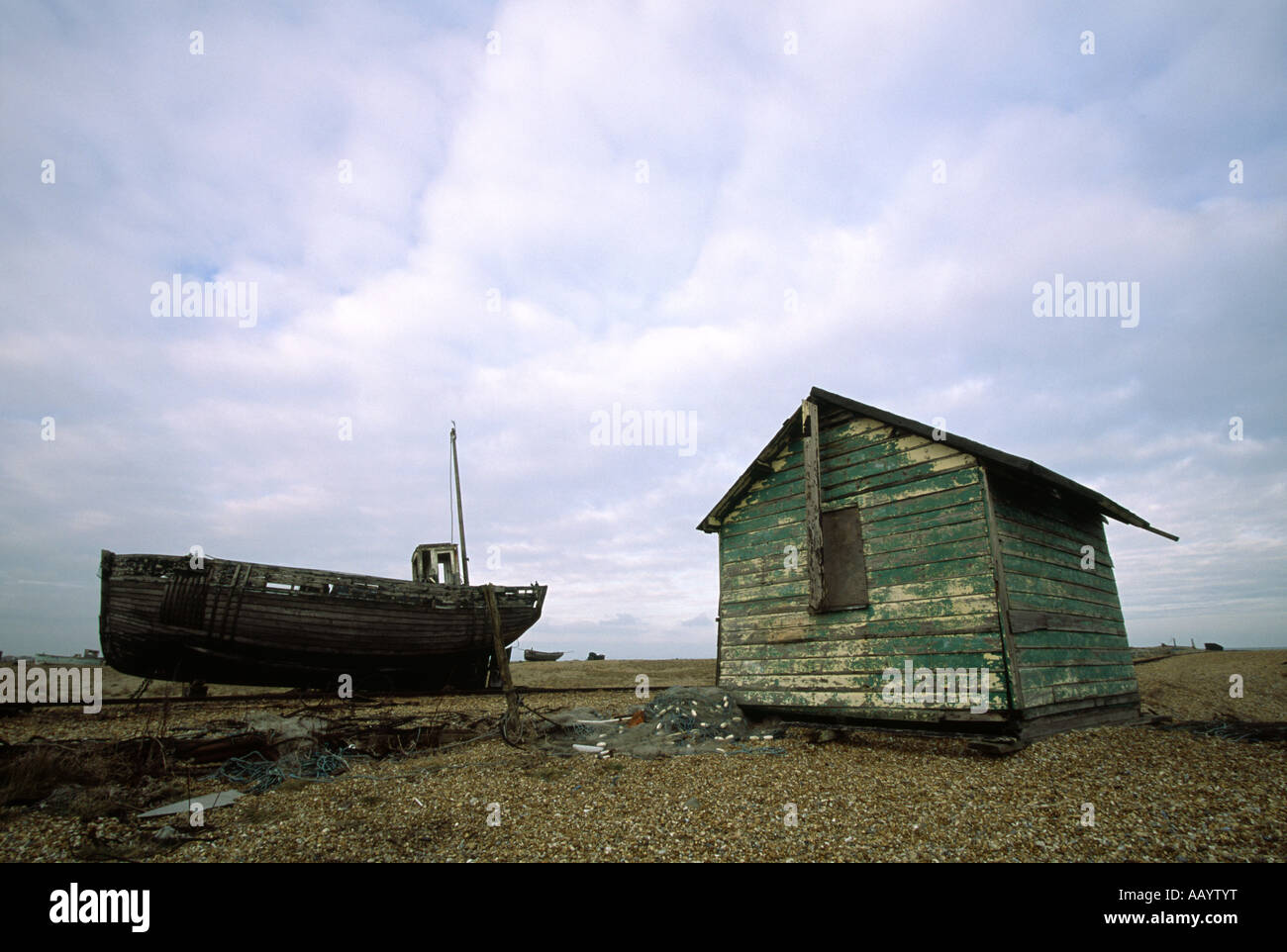 Beach hut and old boat on the beach at Dungeness. Kent, United Kingdom ...