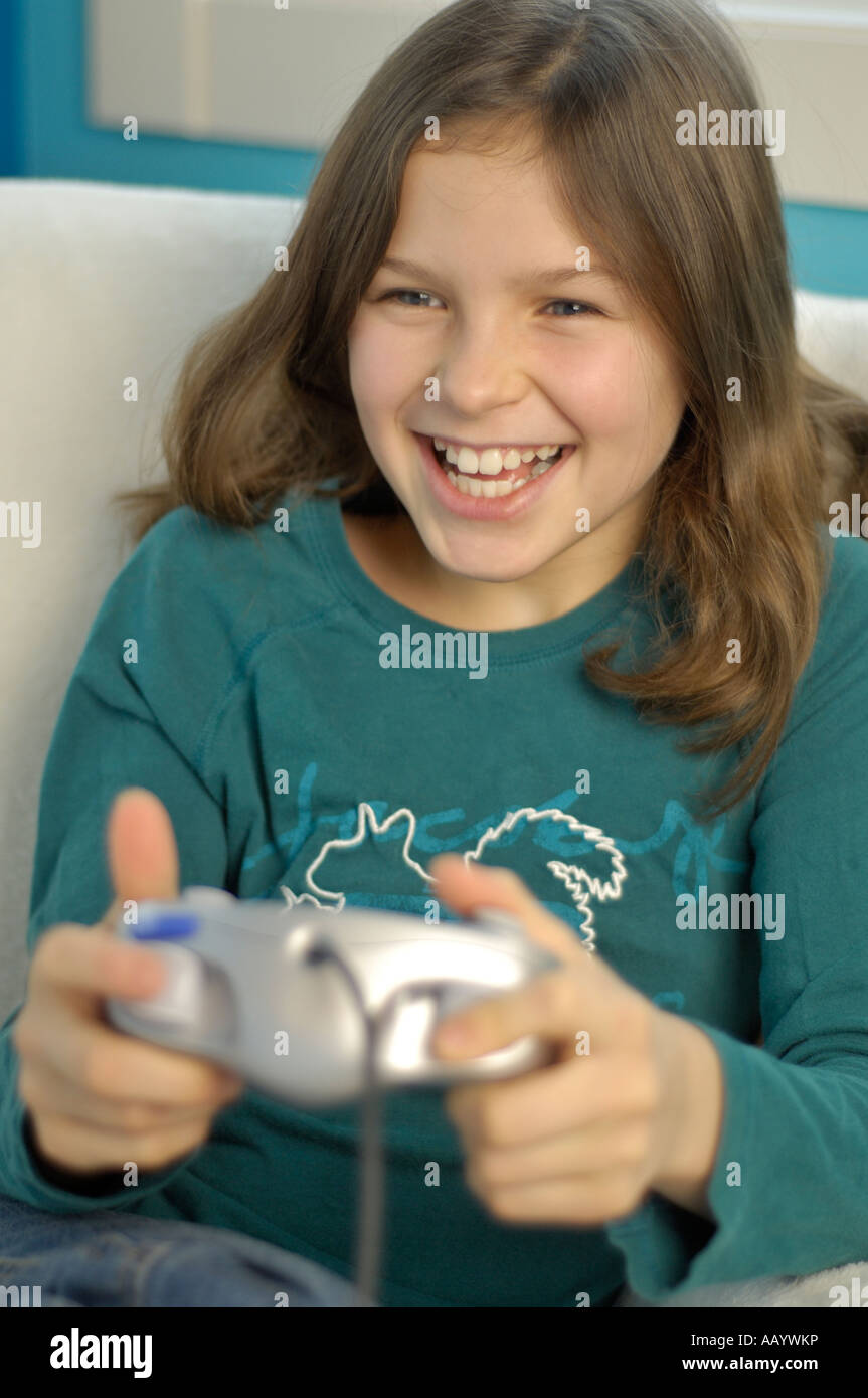 Tween girl playing game system Stock Photo - Alamy