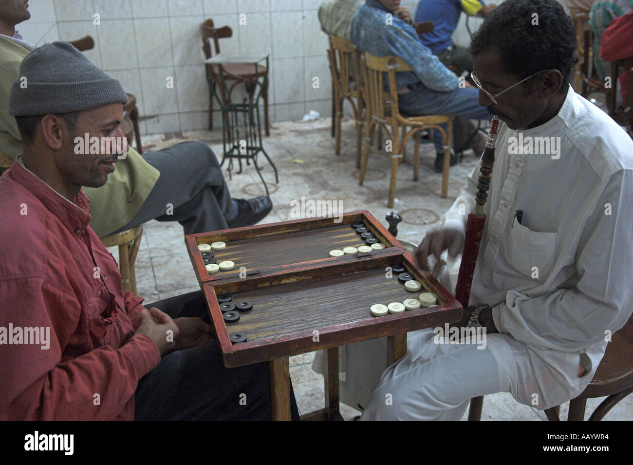 Two Egyptian man one smoking a sheesha pipe playing backgammon Ed Dahar ...