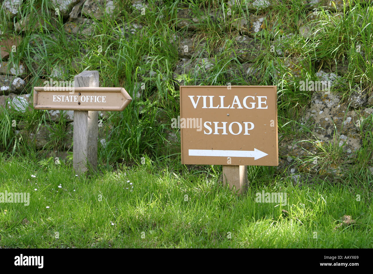 Signs pointing to Estate Offices and Village Shop Stock Photo - Alamy