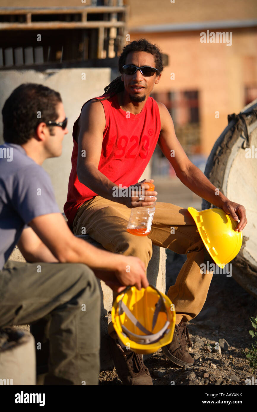 Construction workers sit down for a break Stock Photo - Alamy