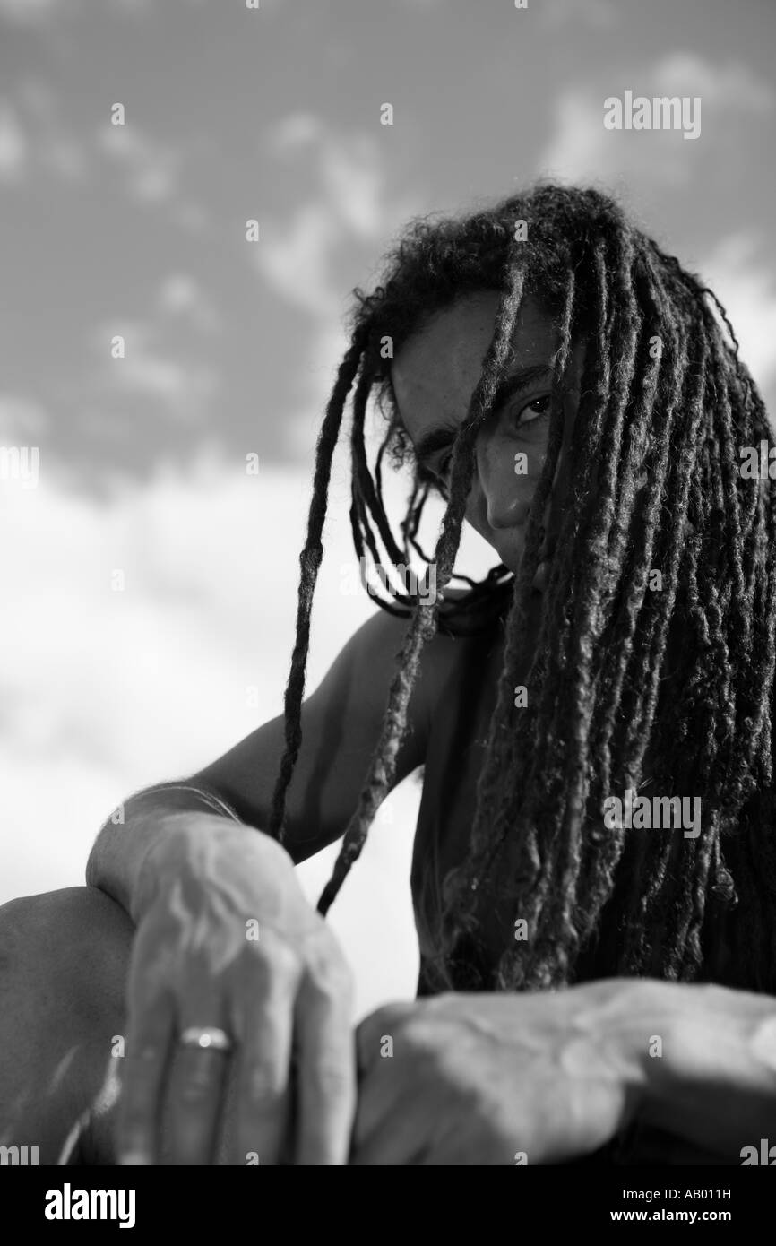 Man with dreadlocks covering face Stock Photo - Alamy