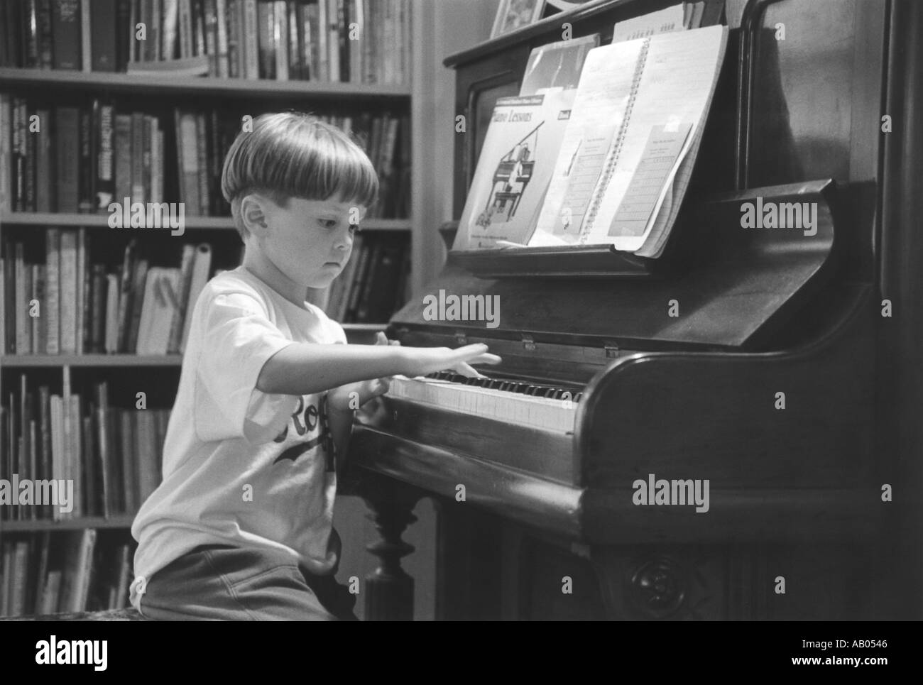 Kid playing piano Black and White Stock Photos & Images - Alamy