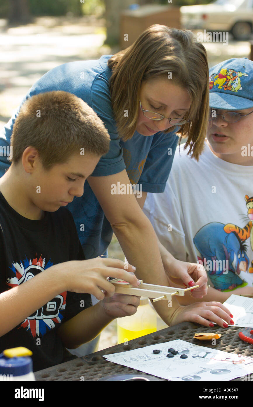 Volunteer teacher helps student with science project at homeschool ...
