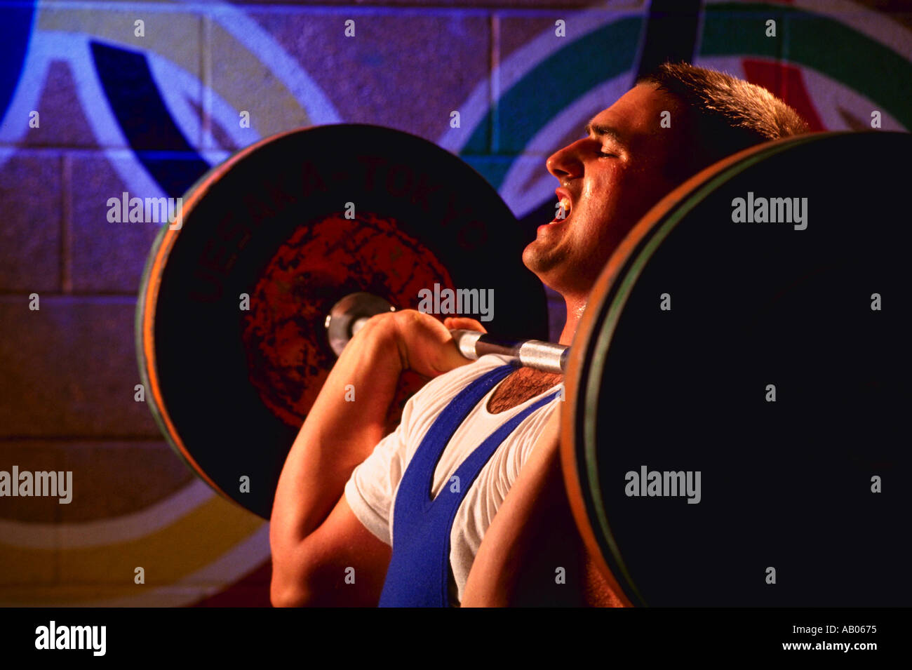 Male weight lifter showing exertion while lifting heavy barbell Stock ...