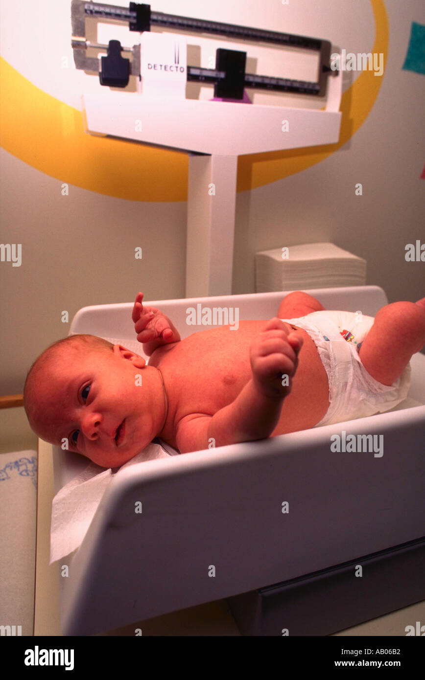 Infant lying on scale in doctor office Stock Photo - Alamy