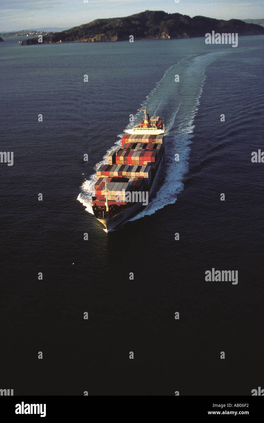 Aerial view of a loaded container ship heading out to sea Stock Photo ...