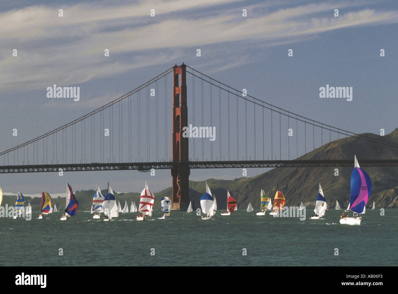 Sailboats hoist colorful spinnakers large sails as they sail by the ...
