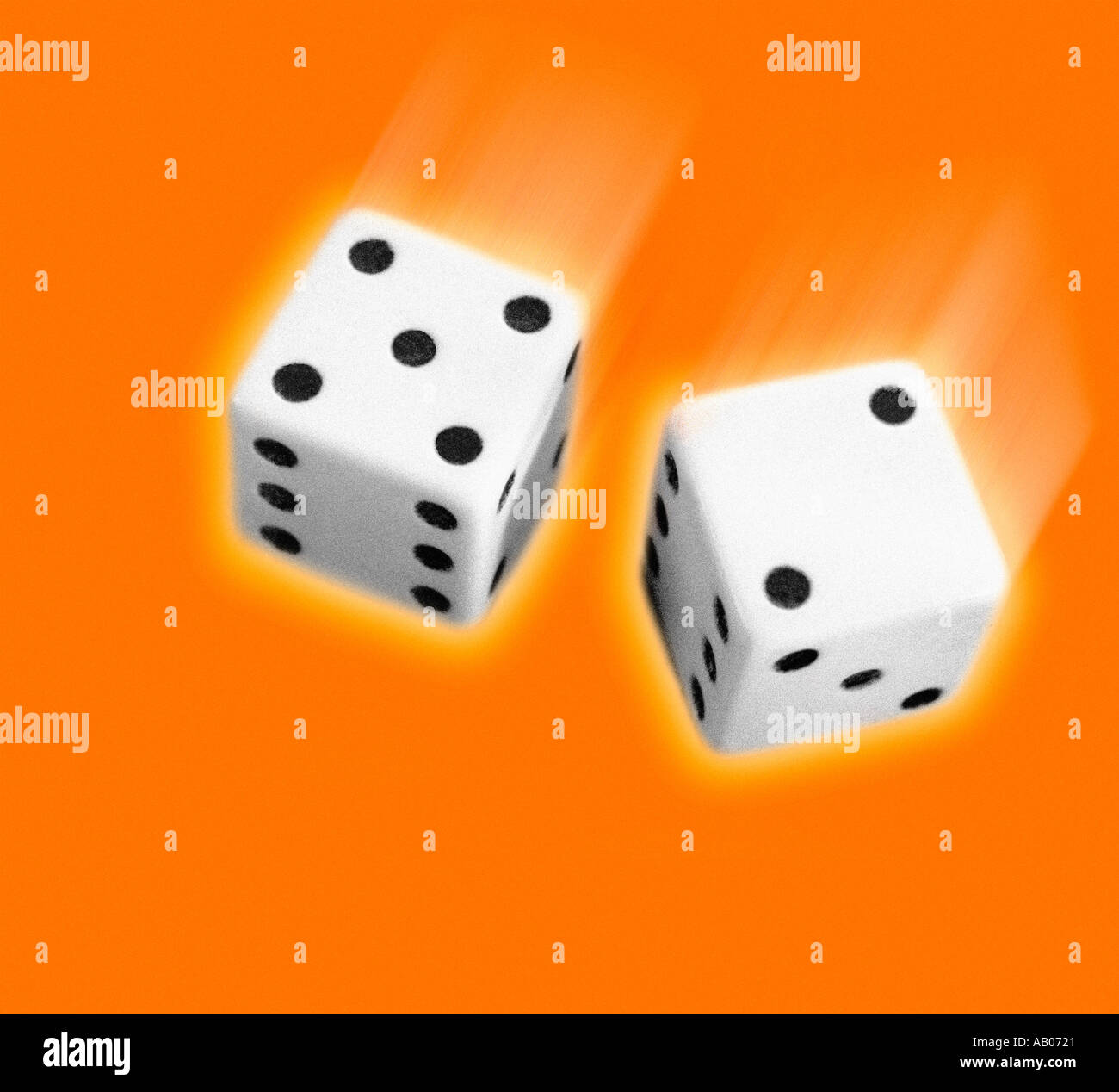 Two dice falling against an orange background Stock Photo - Alamy