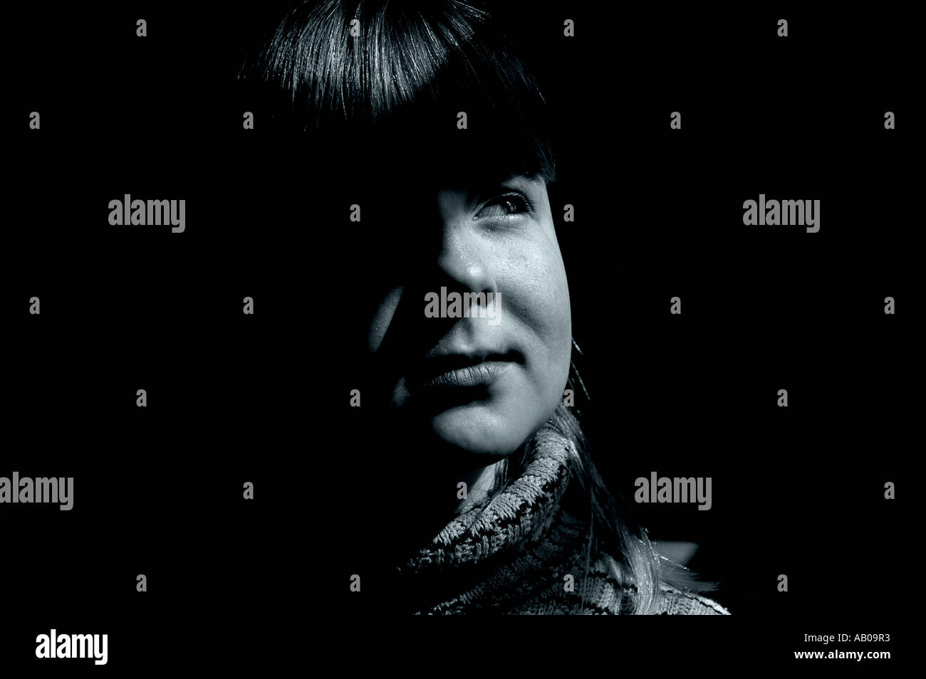 Young girl portrait with half face in deep shadow Stock Photo - Alamy