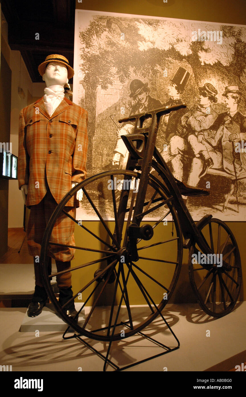 Old wooden bicycle and manikin wearing old fashioned suit from the trun ...