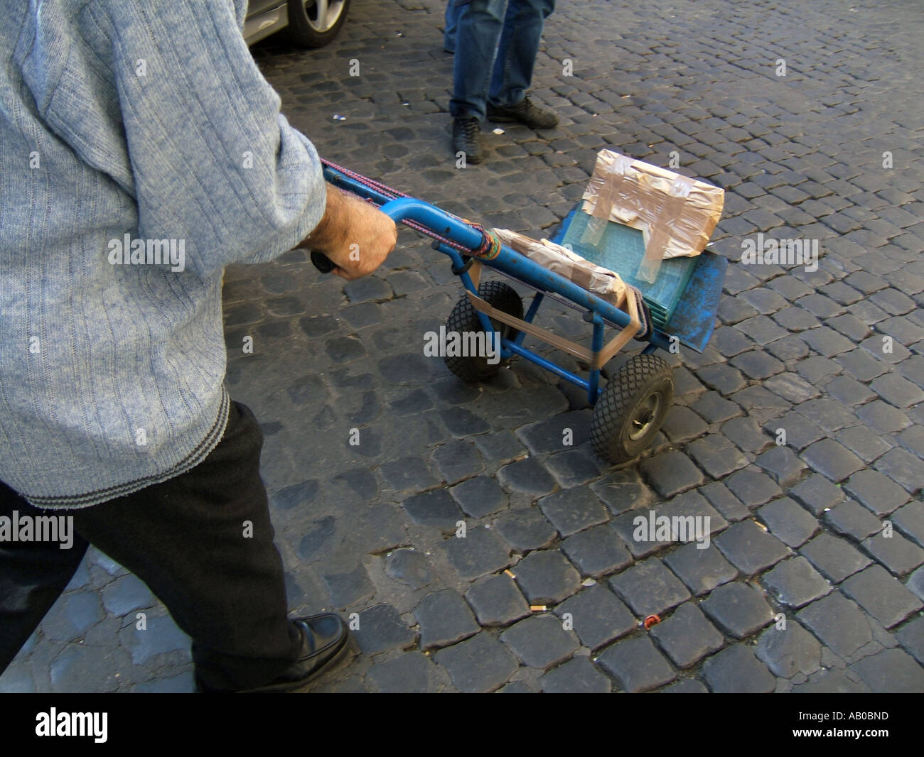 delivery man with empty trolley Stock Photo - Alamy