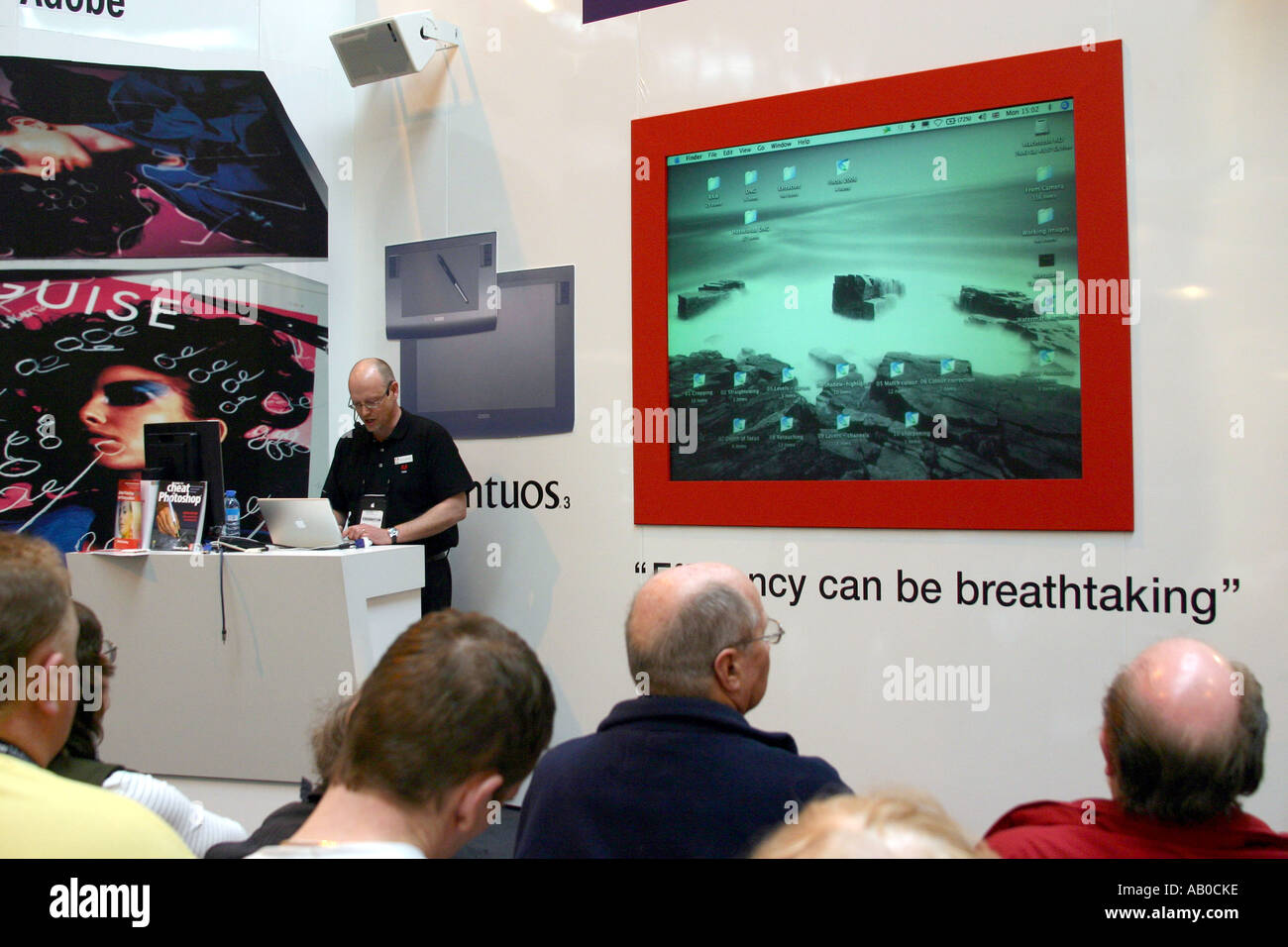 Man delivering lecture on how to use Adobe Photoshop at an exhibition ...
