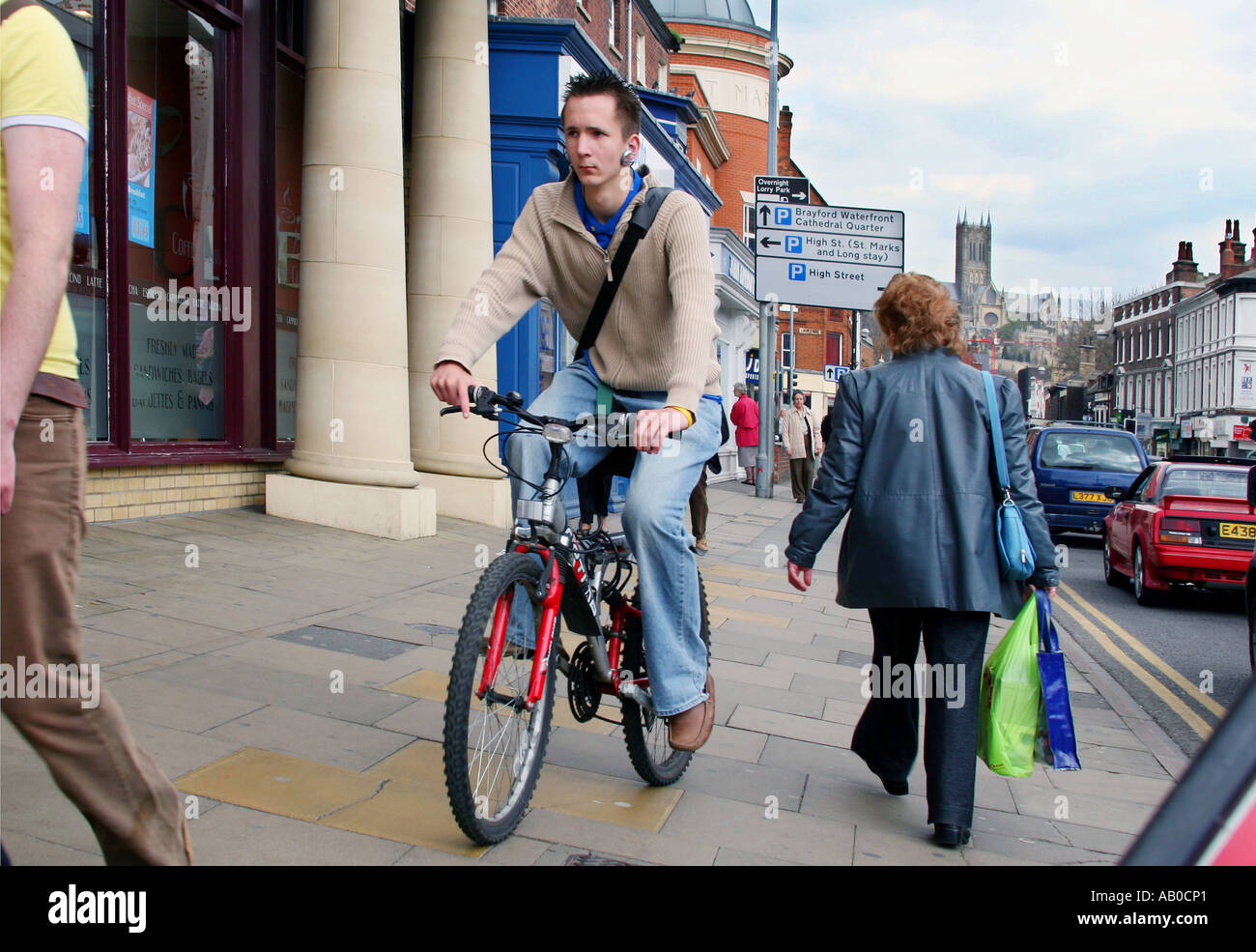 Man riding cycle on the pavement in Lincoln Stock Photo - Alamy