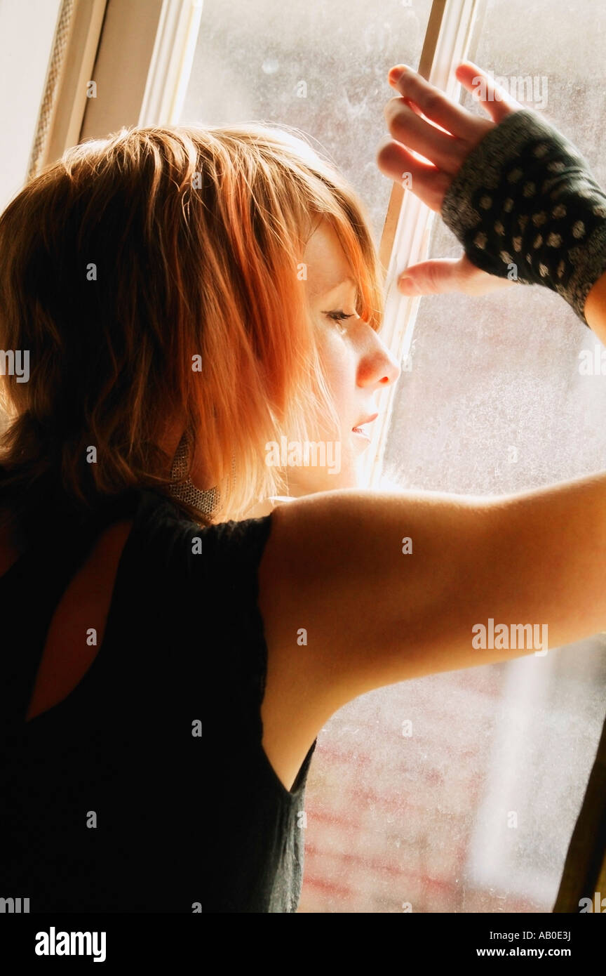 Woman Looking Out The Window Stock Photo - Alamy