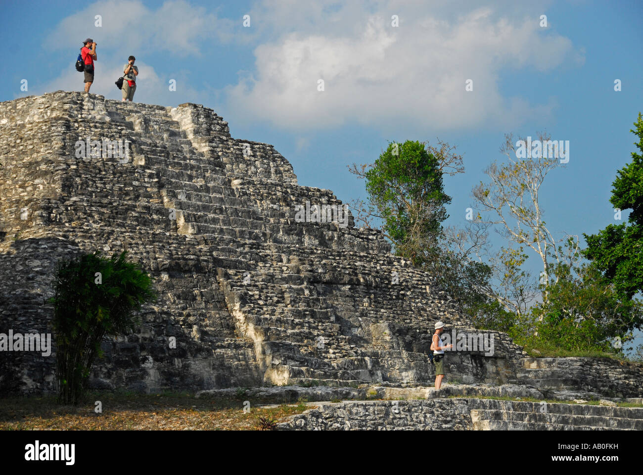 Tourists standing on top of Pyramid in Yaxha Ruins site, Peten ...