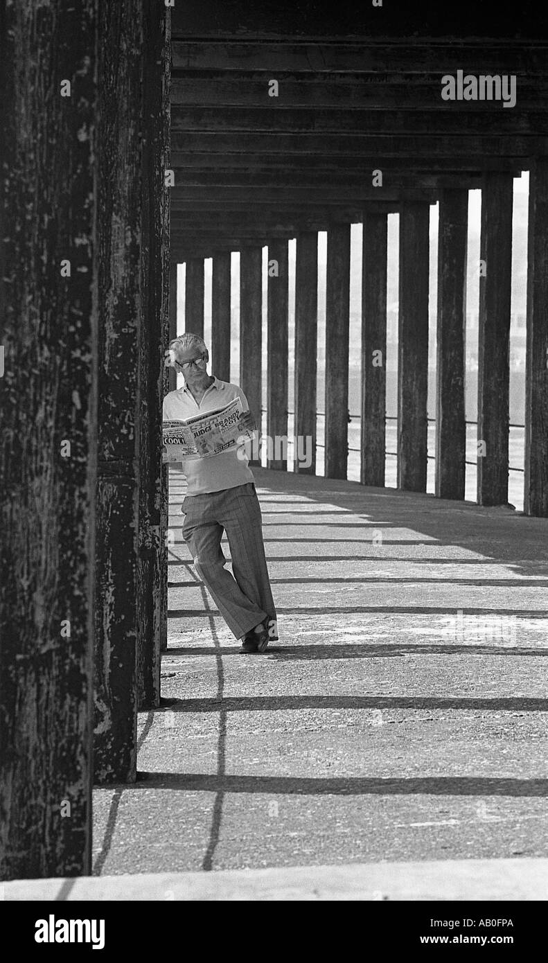 Man newspaper rain Black and White Stock Photos & Images - Alamy