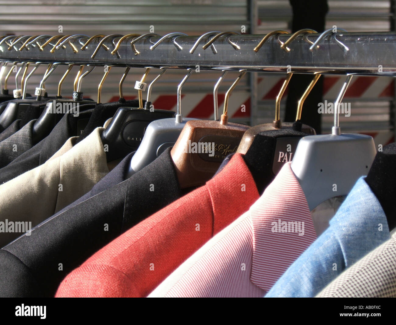men's suits on clothes rail wardrobe Stock Photo - Alamy