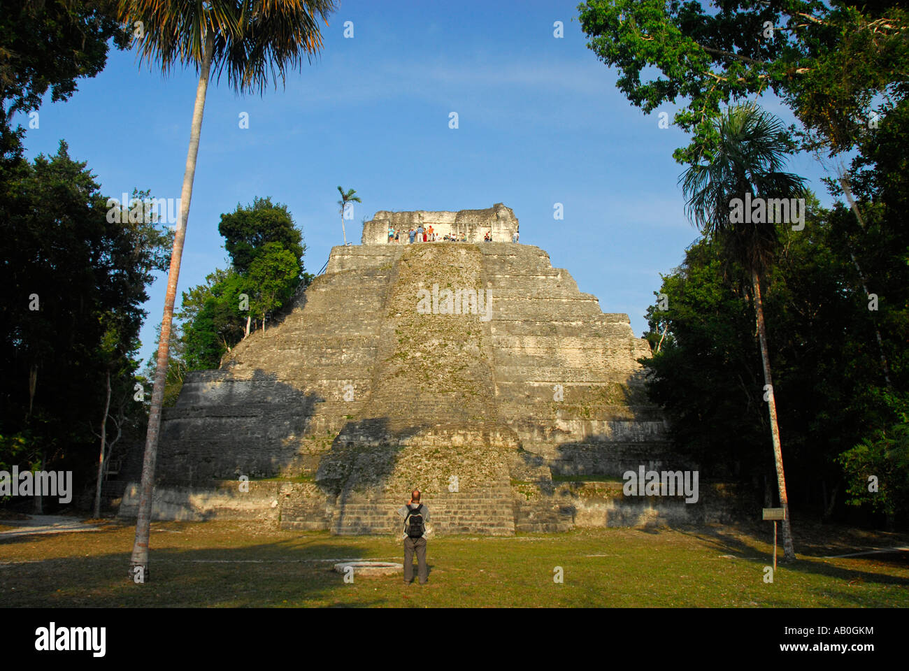 Tourist watching pyramid in Yaxha Ruins site, Peten, Guatemala, Central ...
