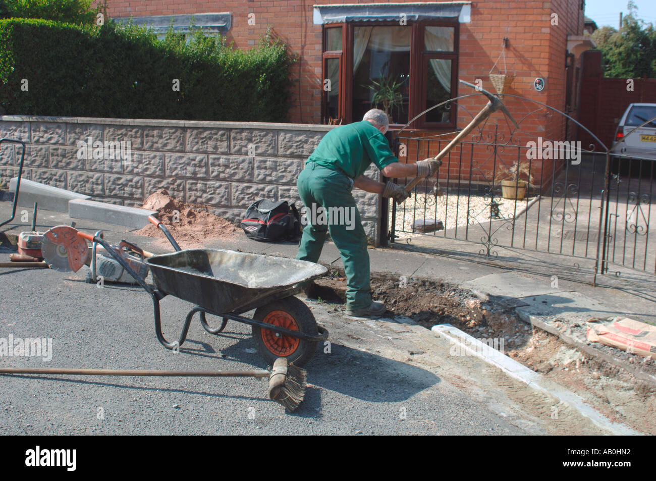 Man Working On Dropping A Curb Stock Photo - Alamy
