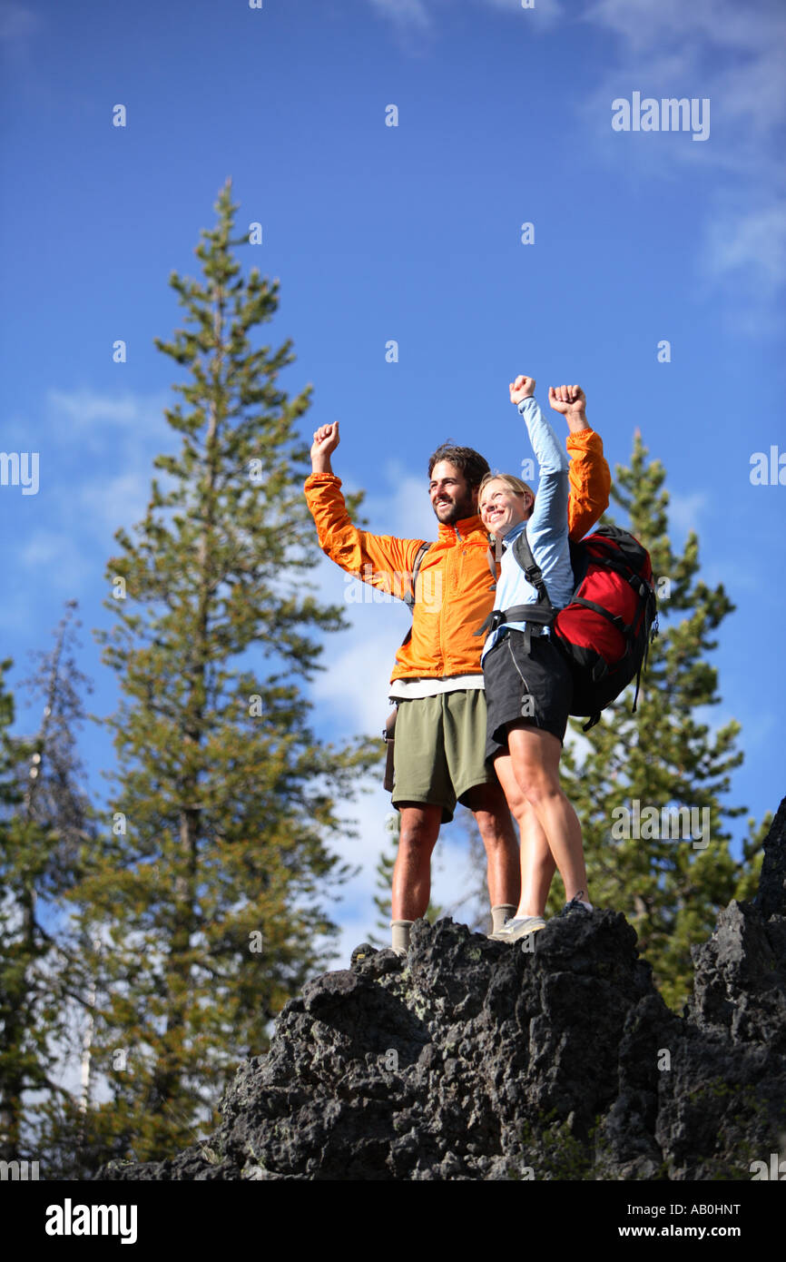 Backpacking couple celebrate at the top of a mountain Stock Photo - Alamy