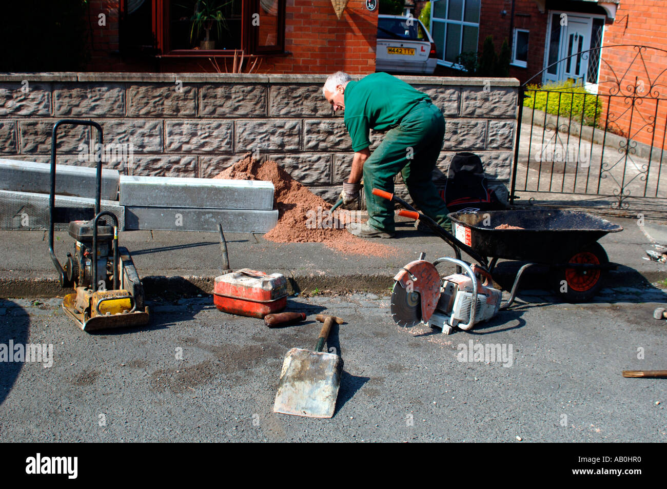 Man Working On Dropping A Curb Stock Photo - Alamy